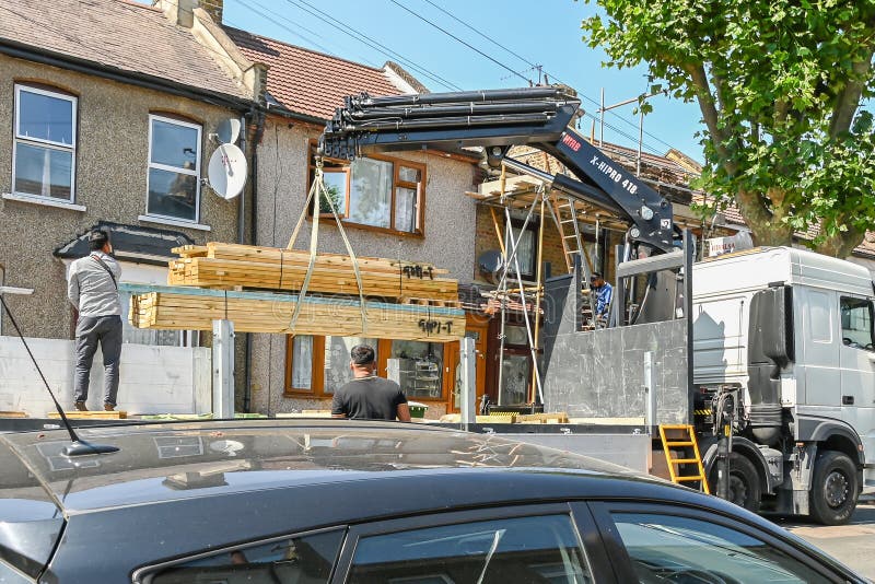 Slingers Stack Lumber Loading on the Roof. London, UK Editorial ...
