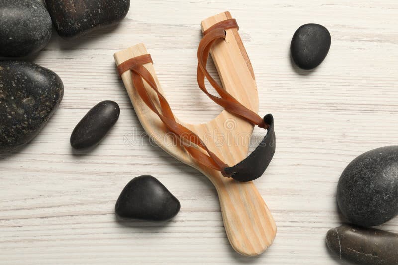 Slingshot with Stones on White Wooden Table, Flat Lay Stock Photo ...