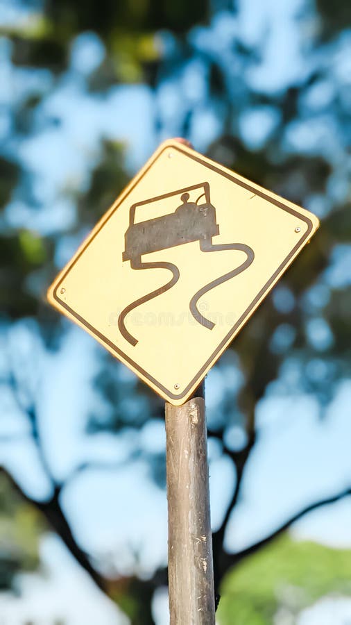 A Slippery Road Warning Sign Post Near the Park Stock Image - Image of ...