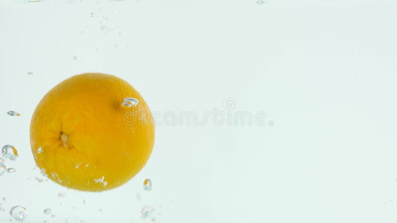 Slo-motion Whole Orange Falling into Water Stock Photo - Image of ...