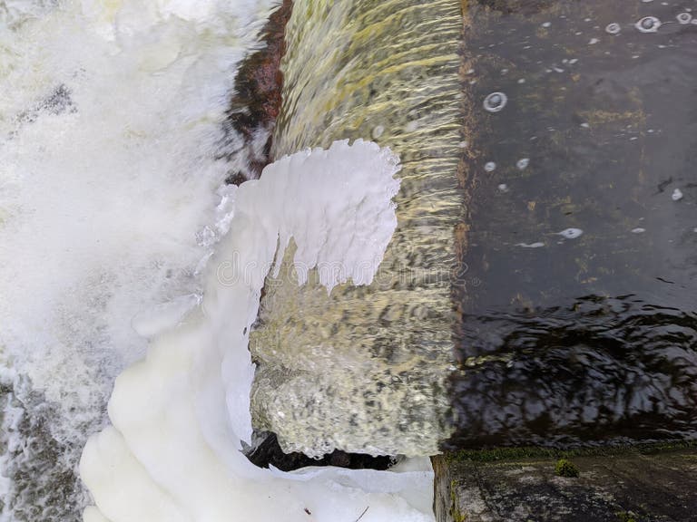 Slope of a Waterfall in Early Spring that Flows Under a Canopy of Ice ...