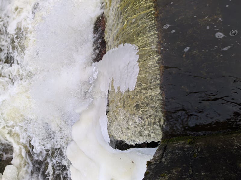 Slope of a Waterfall in Early Spring that Flows Under a Canopy of Ice ...