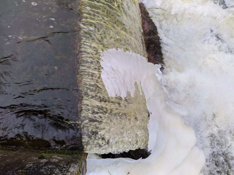 Slope of a Waterfall in Early Spring that Flows Under a Canopy of Ice ...