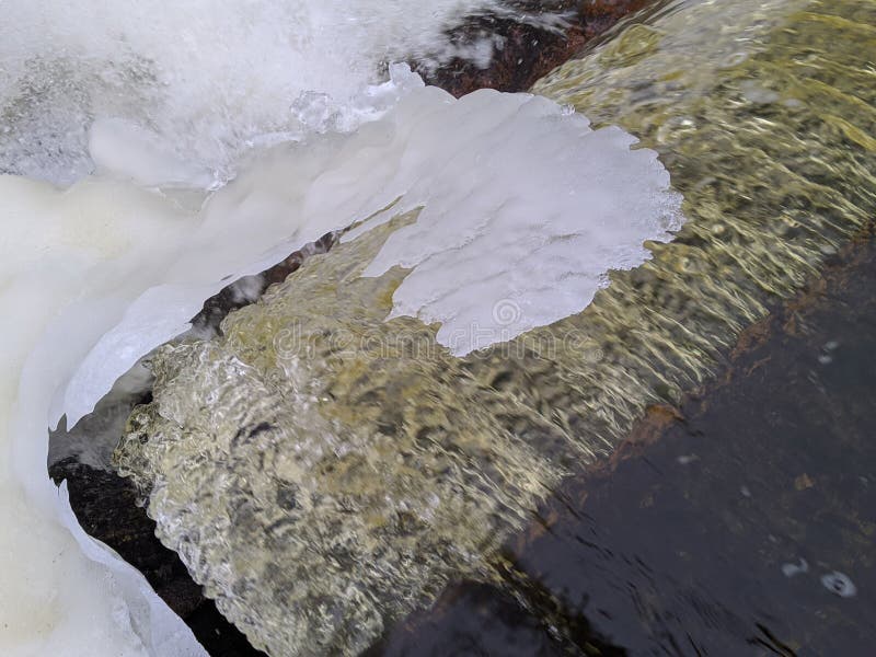 Slope of a Waterfall in Early Spring that Flows Under a Canopy of Ice ...