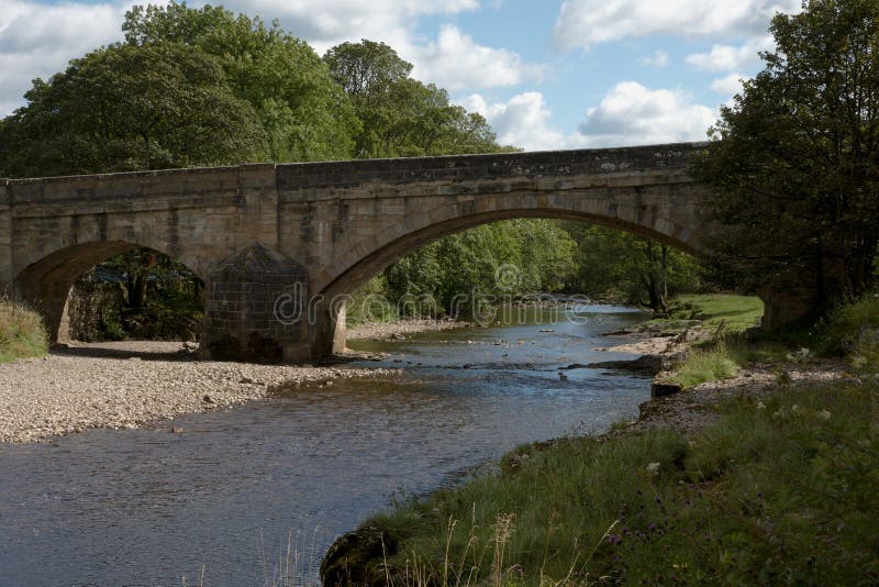Sloping Stone Arch Bridge in the Yorkshire Dales Stock Photo - Image of ...