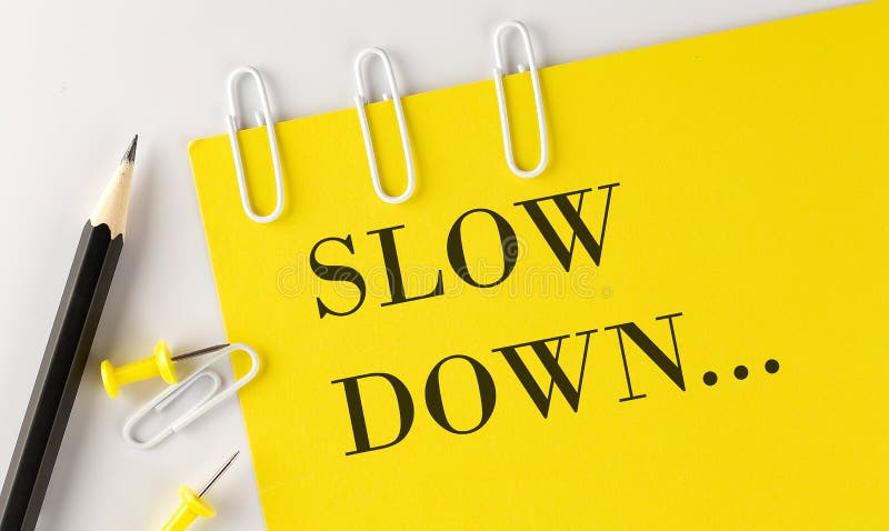 SLOW DOWN Word on the Yellow Paper with Office Tools on White ...