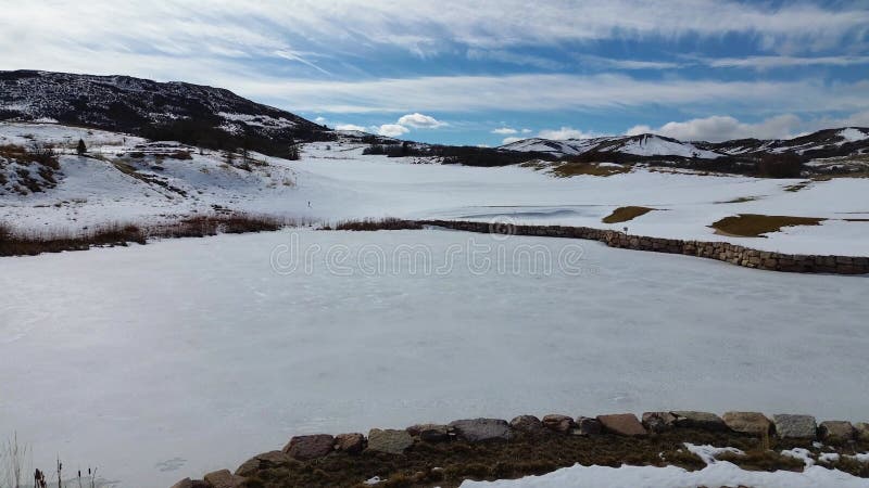 Slow Flyover of a Frozen Golf Course Hazard in Colorado, Captured by a ...