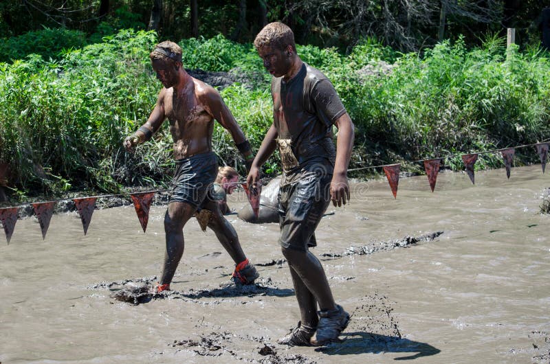 Slow going mud editorial stock image. Image of teens - 25854574