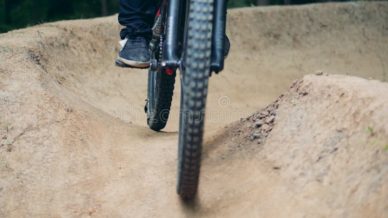 Slow Motion of a Bicycle Riding Along the Dusty Track Stock Footage ...