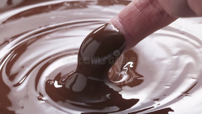 Slow Motion of Checking Melted Premium Dark Chocolate with a Finger ...