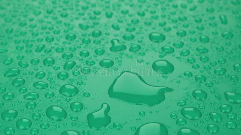 Slow Motion. Close-up of a Drop of Water Falling on a Green Surface, in ...