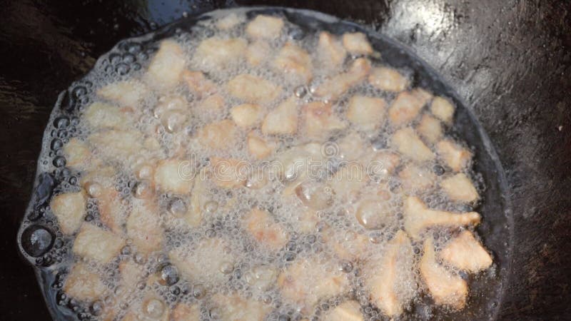Slow Motion Close-up of Lamb Tail Fat Rendering in Cauldron during ...