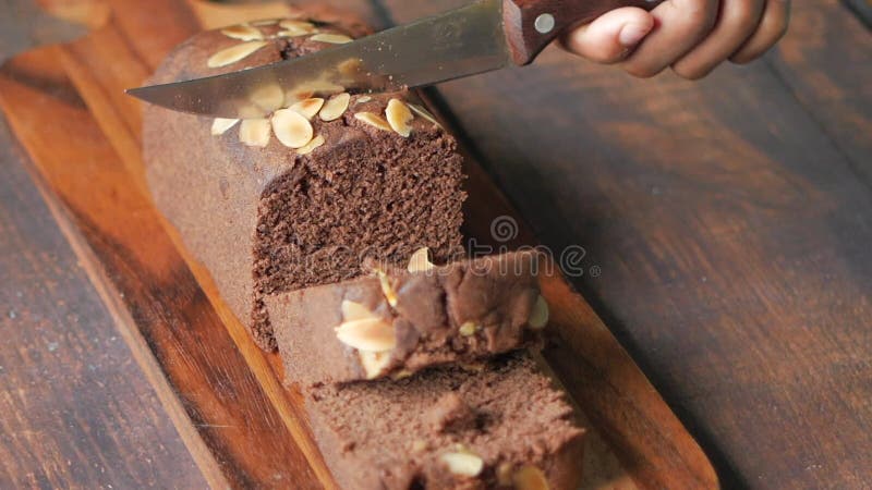 Slow Motion of Hand Cutting a a Bakery Cake on Chopping Board Stock ...