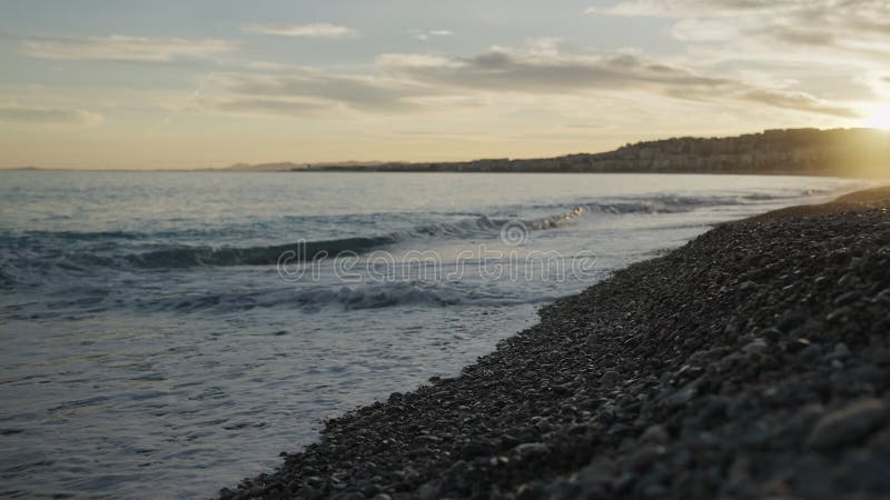 Slow Motion Low Angle Shot of Sunset on a Pebble Beach of Nice Stock ...