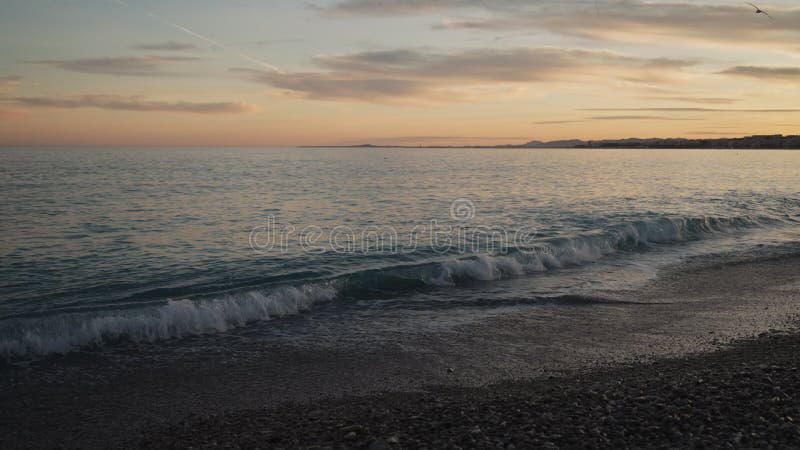 Slow Motion Low Angle Shot of Sunset on a Pebble Beach of Nice Stock ...