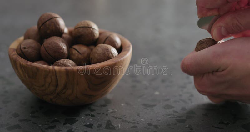 Slow Motion Man Hands Opens Macadamia Nut with Special Key Stock Video ...