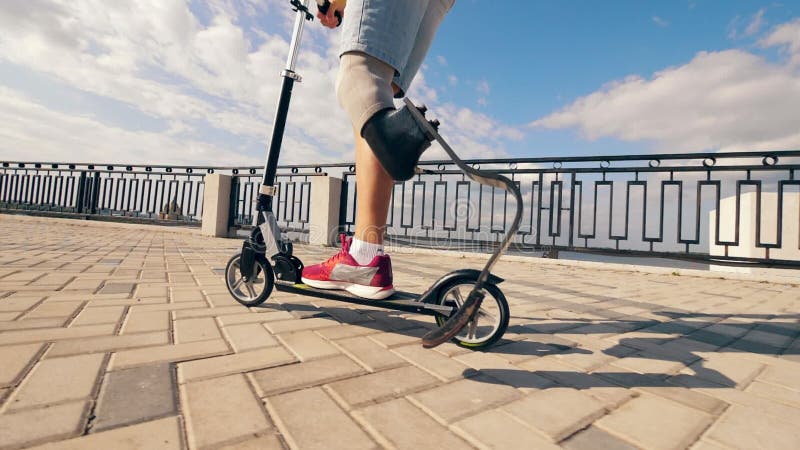 Slow Motion of a Man with Prosthetic Leg Riding a Scooter Stock Video ...