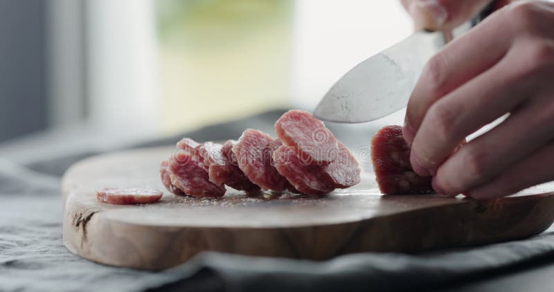 Slow Motion Man Slicing Salami on Olive Board Stock Video - Video of ...