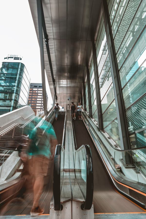 Slow Motion of Man Walking Up Escalators in City Stock Photo - Image of ...