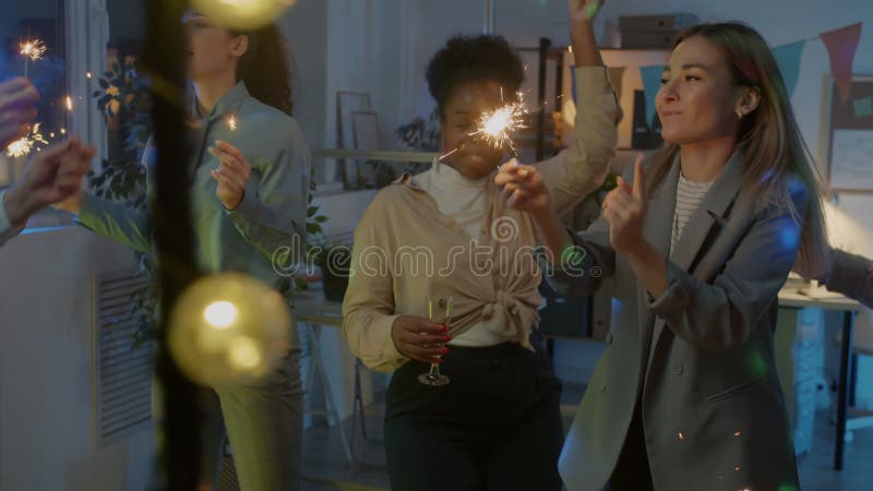 Slow Motion of Office Workers Dancing at Work Party with Sparklers and ...