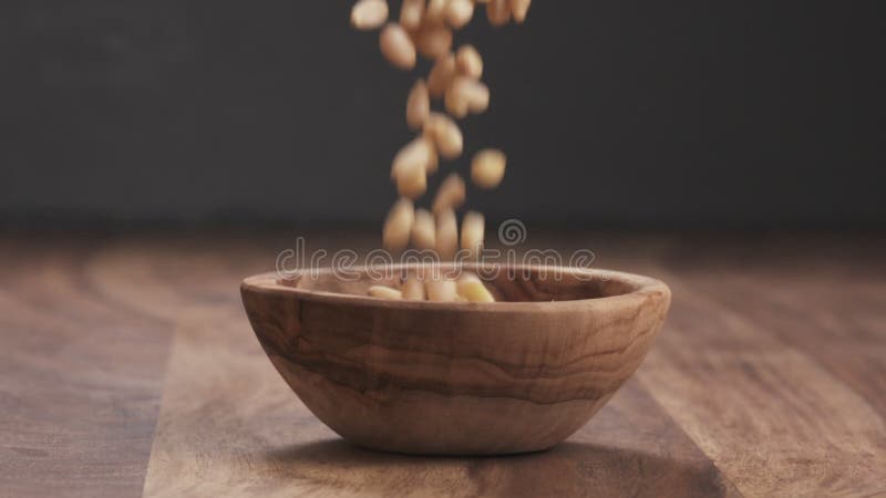 Slow Motion Pine Nuts Falling into Wood Bowl Stock Footage - Video of ...