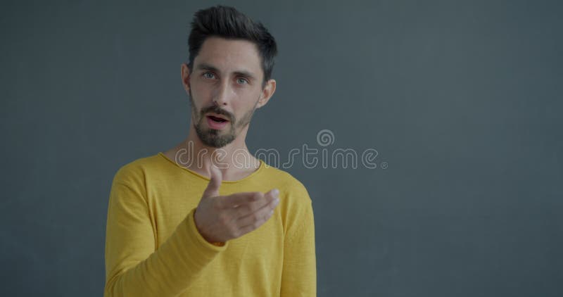 Slow Motion Portrait of Guy Pointing at Empty Space and Showing Thumbs ...