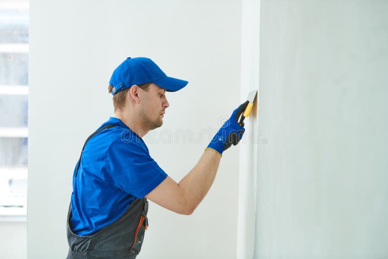 Refurbishment. Worker Spackling a Wall with Putty Stock Photo - Image ...