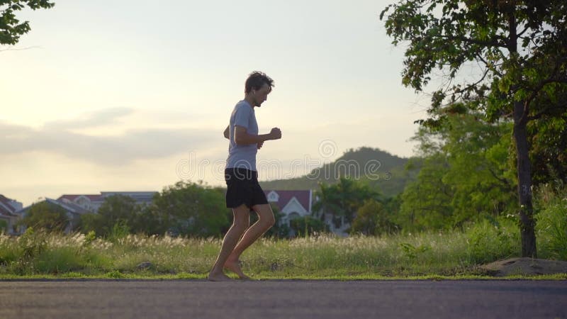 Slow Motion Shot of a Young Man Running Barefoot. Barefoot Running ...