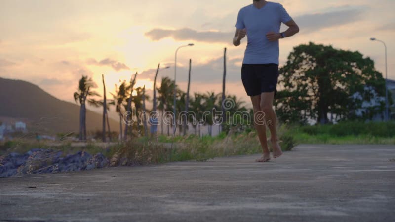 Slow Motion Shot of a Young Man Running Barefoot. Barefoot Running ...