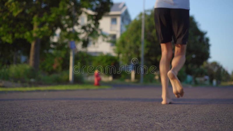 Slow Motion Shot of a Young Man Running Barefoot. Barefoot Running ...