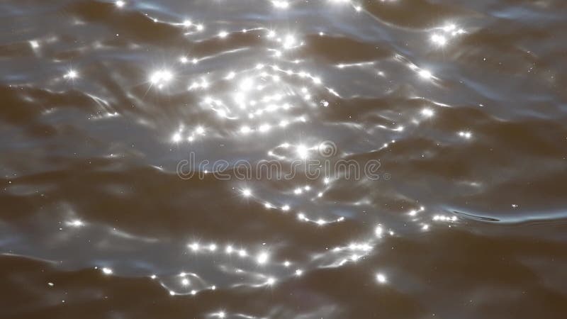 Slow Motion of Sunlight Dancing Across Dark Water Surface, Creating ...