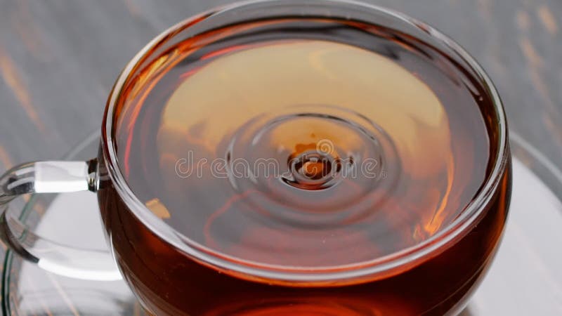 Slow Motion Tea Splash. Droplet Falling into Golden Tea Stock Footage ...