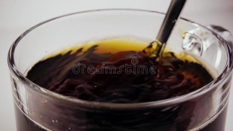 Slow Motion. a Teaspoon Drops into Tea Closeup Stock Video - Video of ...