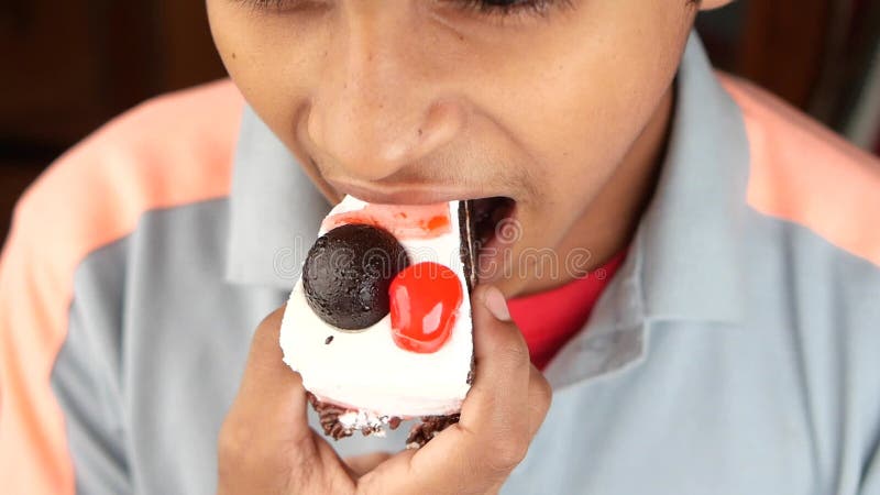Slow Motion of Teenage Boy Eating a Cake Stock Video - Video of cream ...