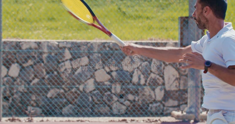 Slow Motion of a Tennis Player Hitting the Ball during a Tennis Game ...
