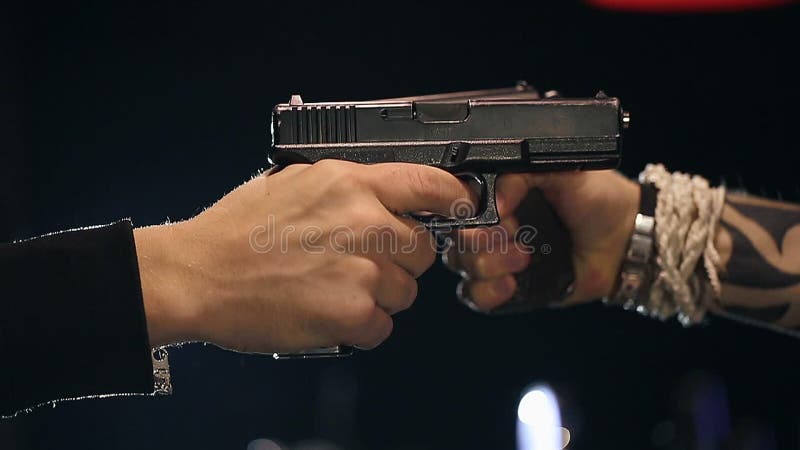 SLOW MOTION: Two Male Hands with Guns Take Aim at Each Other Stock ...