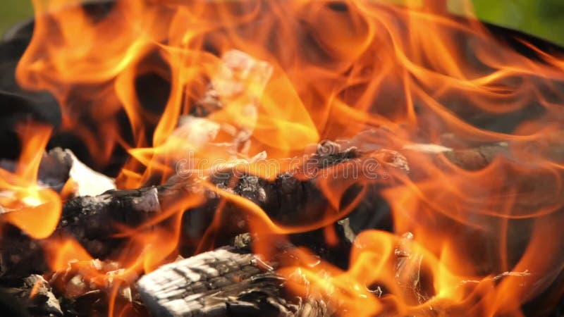 A Slow-motion Video of a Burning Fire Pit. the Flames are Bright Orange ...