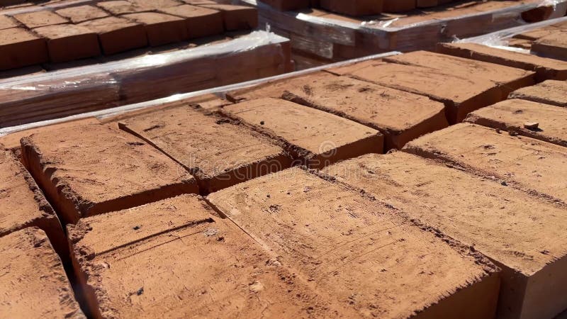 Slow Motion Video with Pallets of Solid Red Bricks at a Construction ...