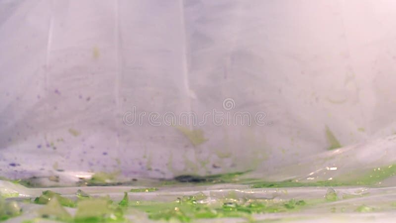 Slow-motion View of a Falling and Breaking Glass Vase Filled with Green ...