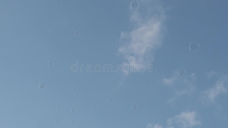 Slow Motion View of Soap Balloons Floating in a Light Blue Sky Guided ...