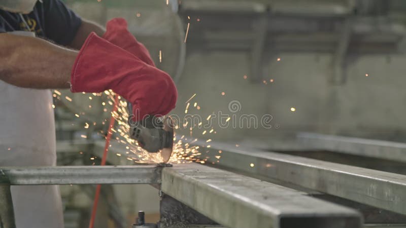 Slow Motion of a Worker Using Metal Grinder with Sparks Flying at a ...