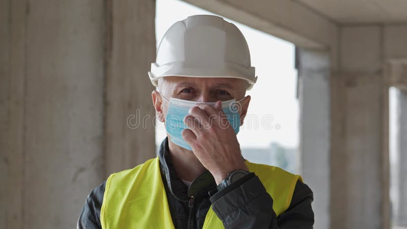 Slow Motion Workman at Construction Site Puts on Medical Protective ...