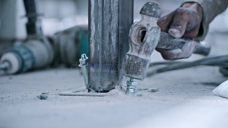 Slow-motioned Closeup of the Dirty Hand of a Worker Striking a Bolt ...