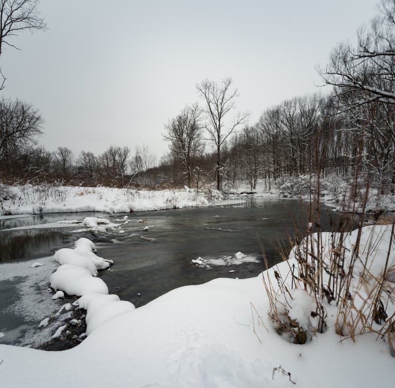 Slow Moving Dark River Rounding Its Way through a Snow Covered Forest ...