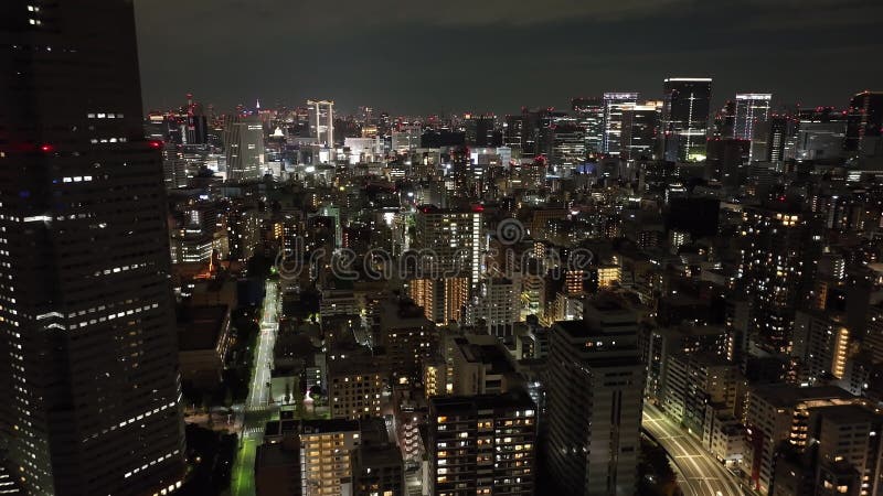 Slow Pullback on High Rise Over Sprawling Modern City at Night Stock ...