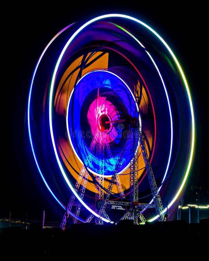 Slow Shutter Image of a Rotating Giant Colorful Ferris Wheel Spinning ...