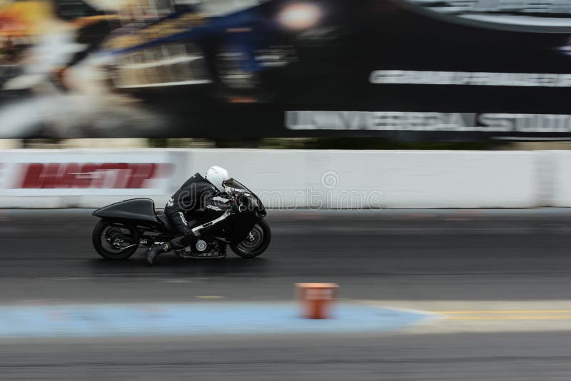 Slow Shutter Speed Shot of a Motorcycle Accelerating Down a Race ...