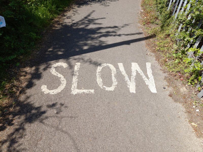 A Slow Sign on a Cycling Path Stock Photo - Image of walkway, soil ...