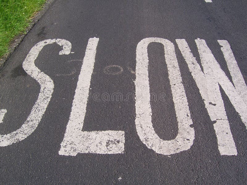 Slow Sign painted on road stock photo. Image of white - 61932004