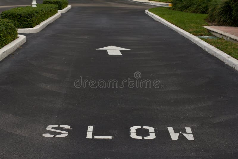 Slow sign on the road stock photo. Image of white, surface - 17364132